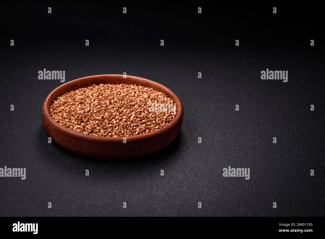 Large grains of raw buckwheat porridge are brown in color. Cooking ...