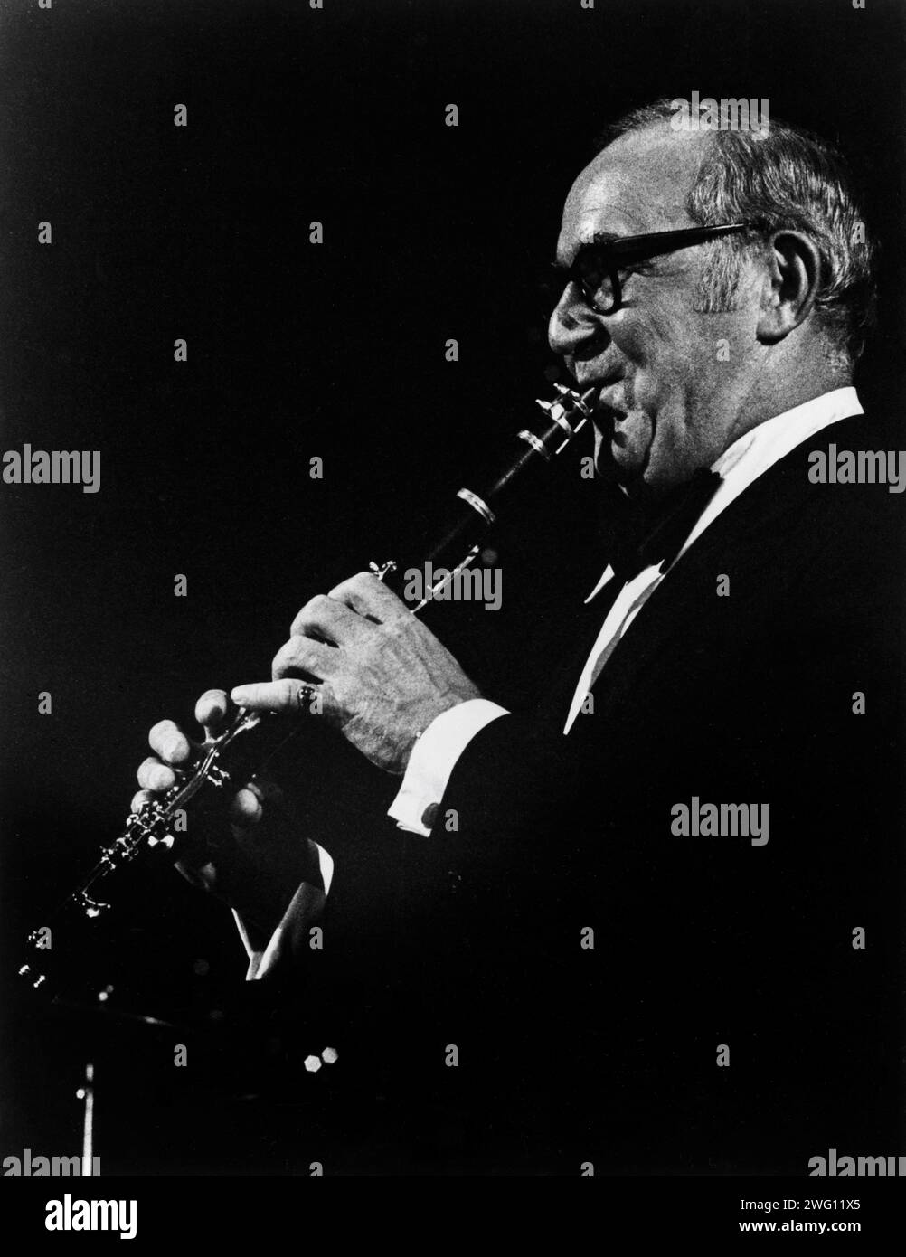 BENNY GOODMAN in concert on stage playing his Clarinet candid portrait ...