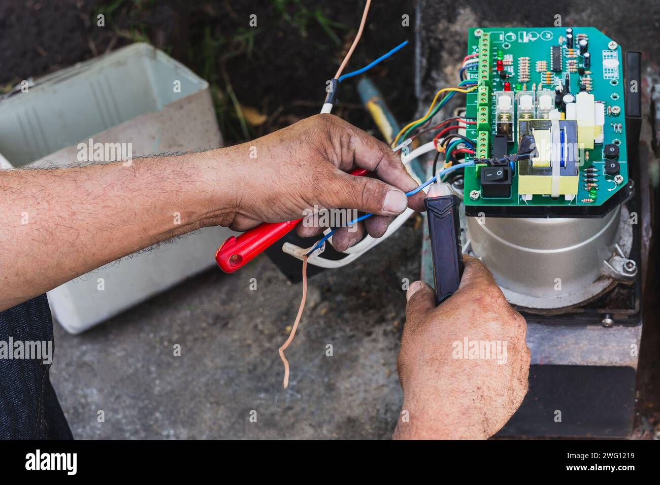 Electrical engineer checking circuit board at home Stock Photo - Alamy