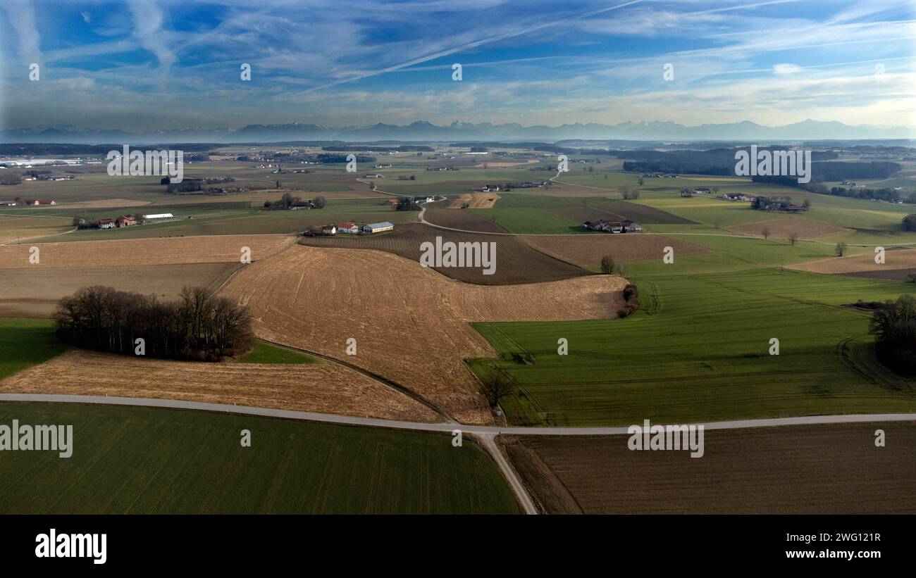 Rural landscape with scattered farms in the foothills of the Alps, in ...