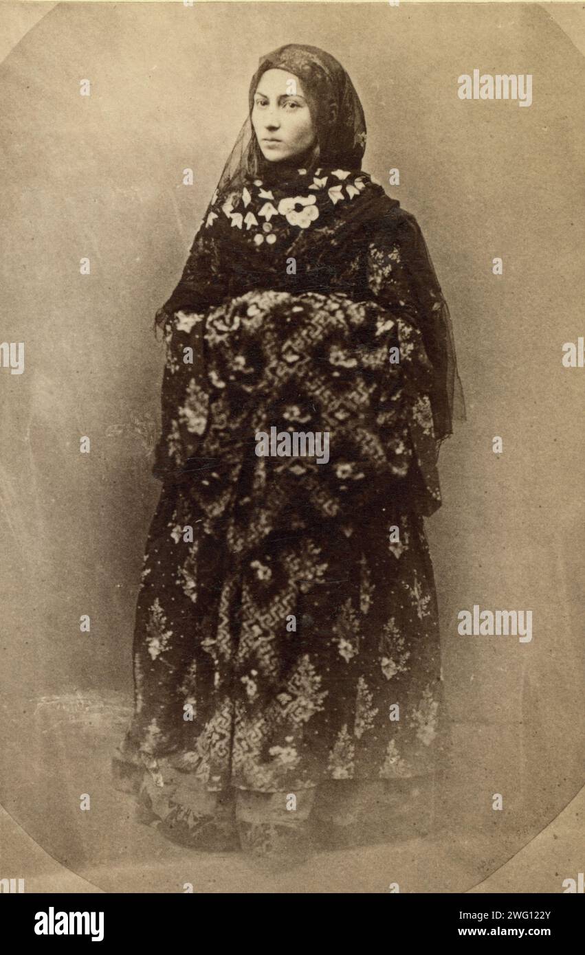 Full-length portrait of a woman in traditional dress, facing slightly ...