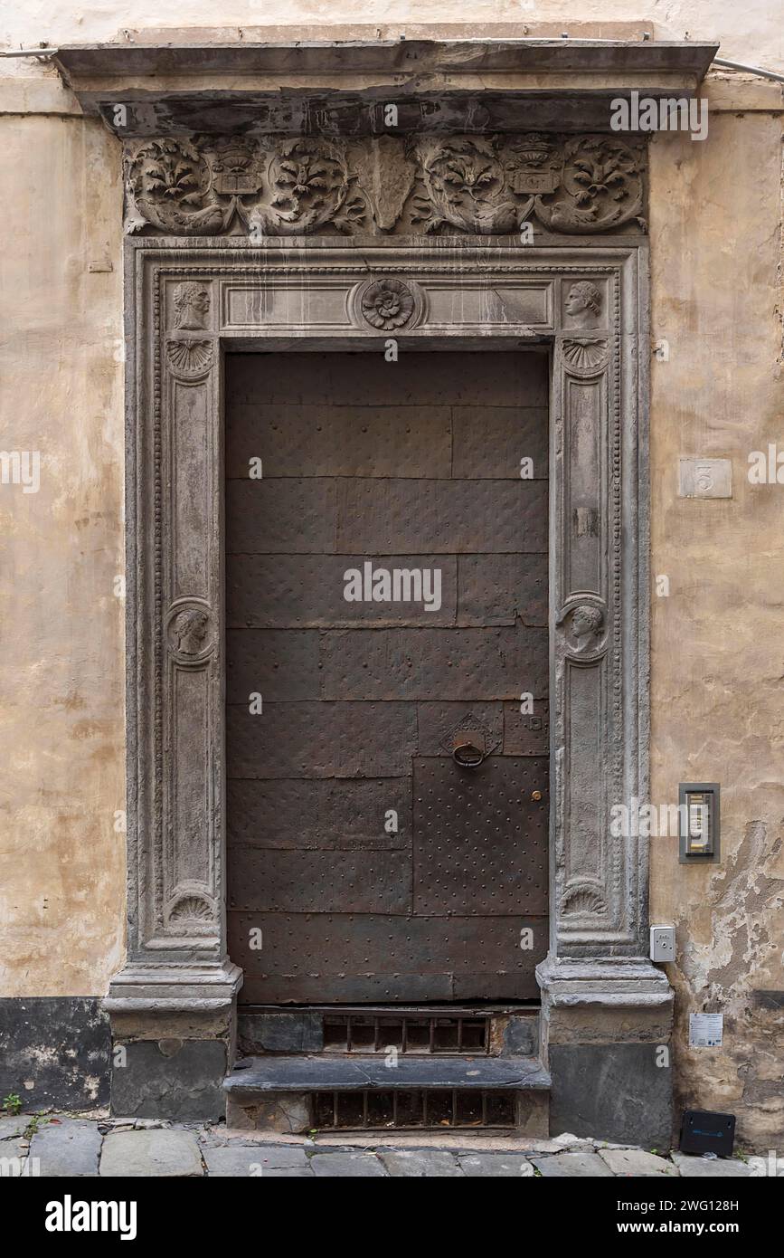 Historic entrance door with decorative floral reliefs on the frame in ...