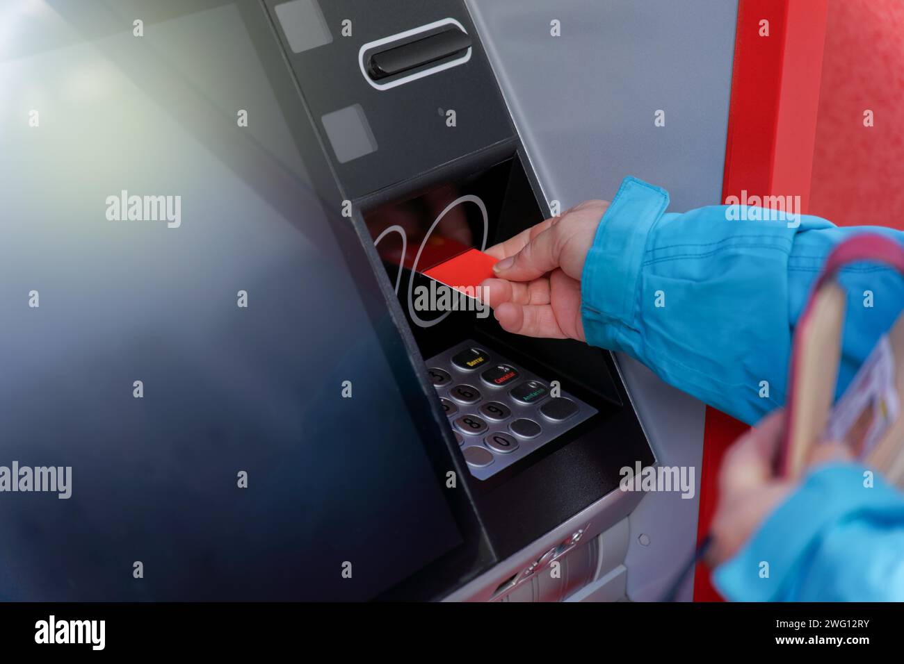 Person at atm blue coat hi-res stock photography and images - Alamy