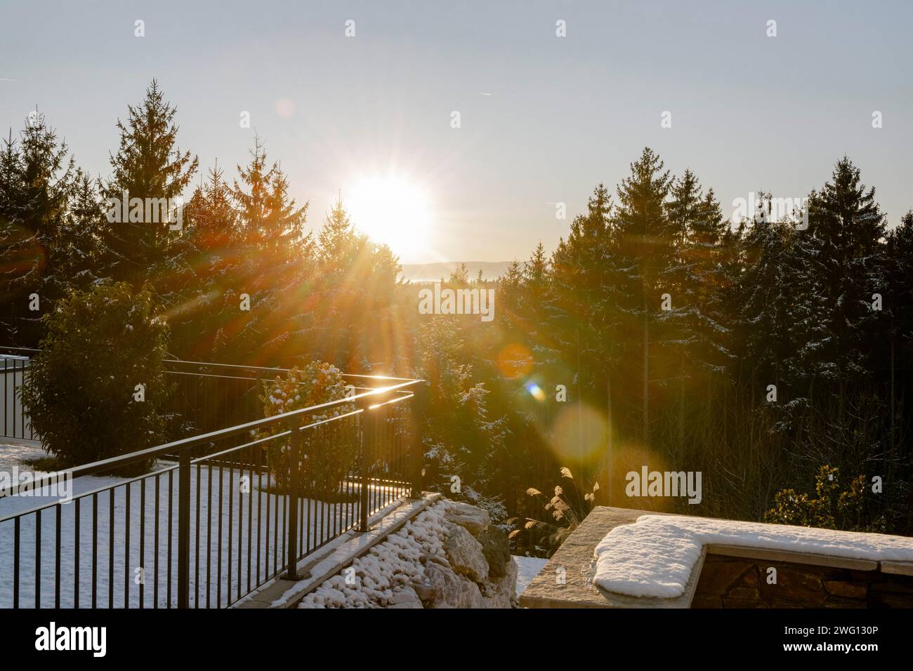 Setting winter sun with landscape Stock Photo - Alamy