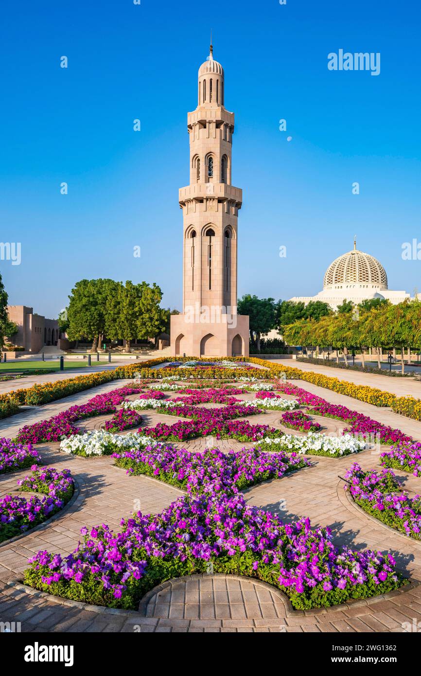 Sultan Qaboos Grand Mosque, minaret with blooming flowers in gardens ...
