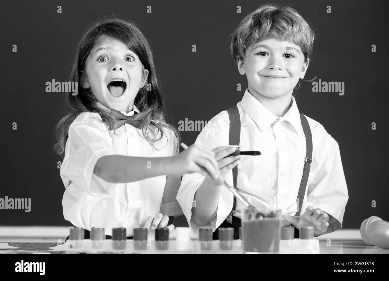 Funny excited children girl and boy drawing with coloring pens. Cute ...