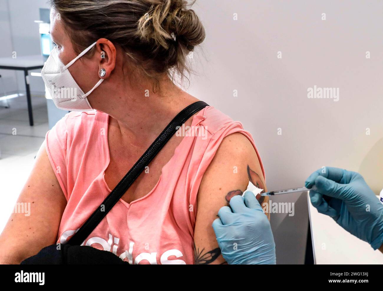 A woman receives a booster vaccination from Moderna against Covid 19 at ...