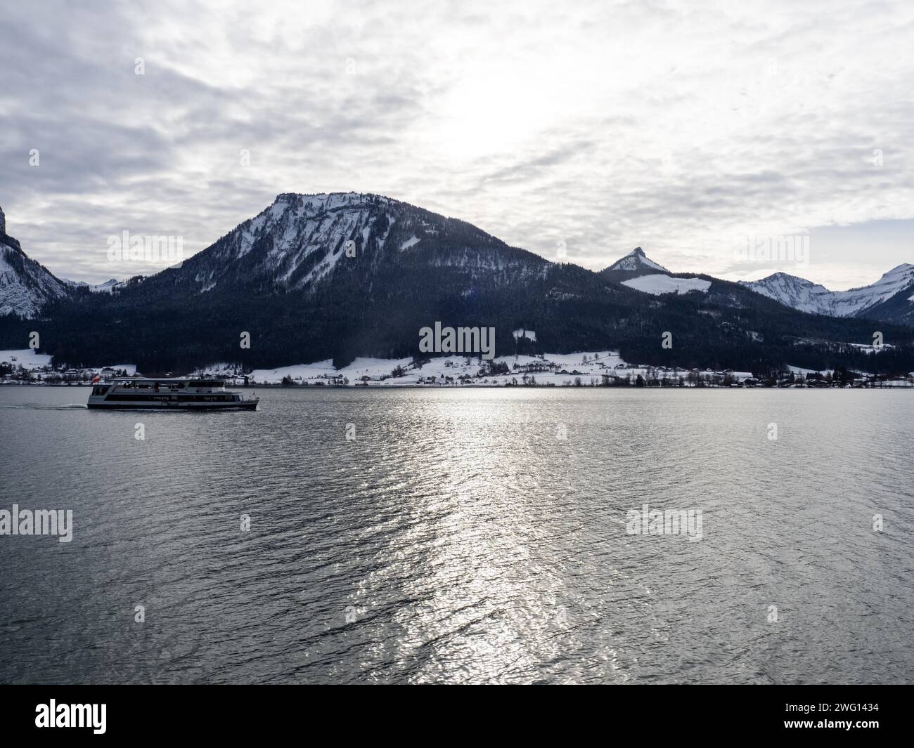 Snow-covered mountain peaks, excursion boat on Lake Wolfgangsee, Lake ...