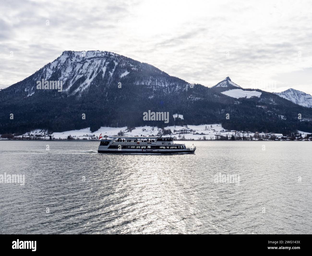 Snow-covered mountain peaks, excursion boat on Lake Wolfgangsee, Lake ...
