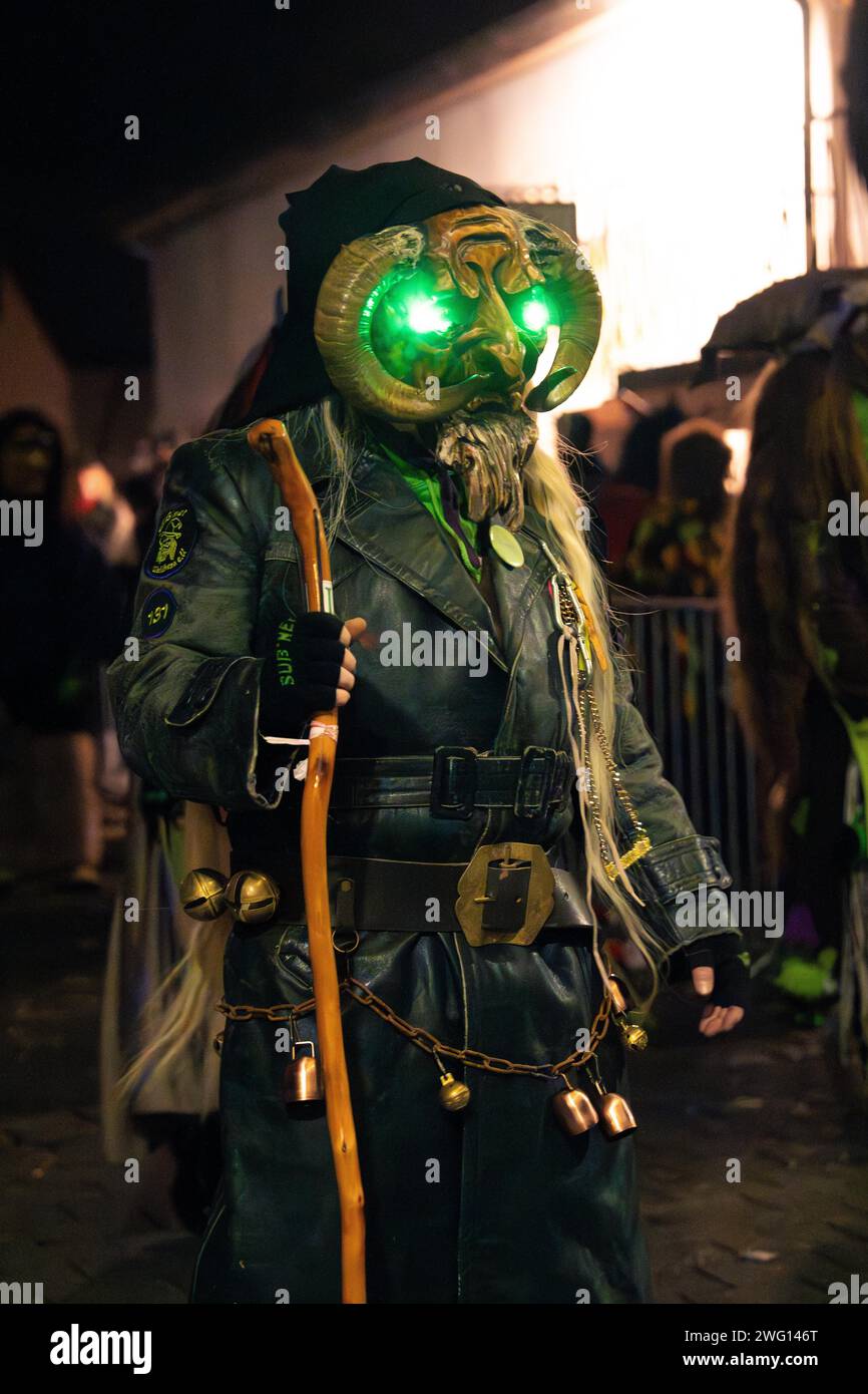 Carnival figure with military-style costume and mask with glowing green ...
