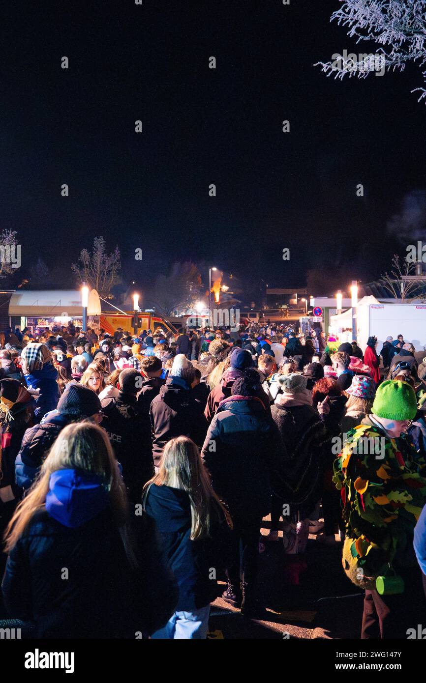 Tightly packed crowd celebrates carnival at night in winter, carnival ...