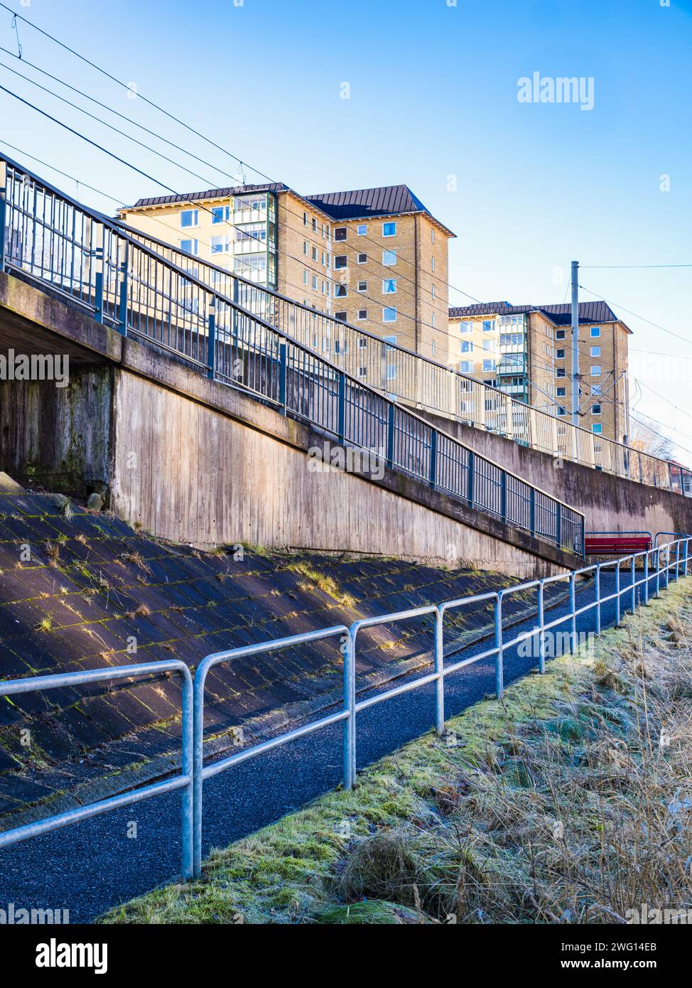 This image captures apartment buildings towering above a sloped ...