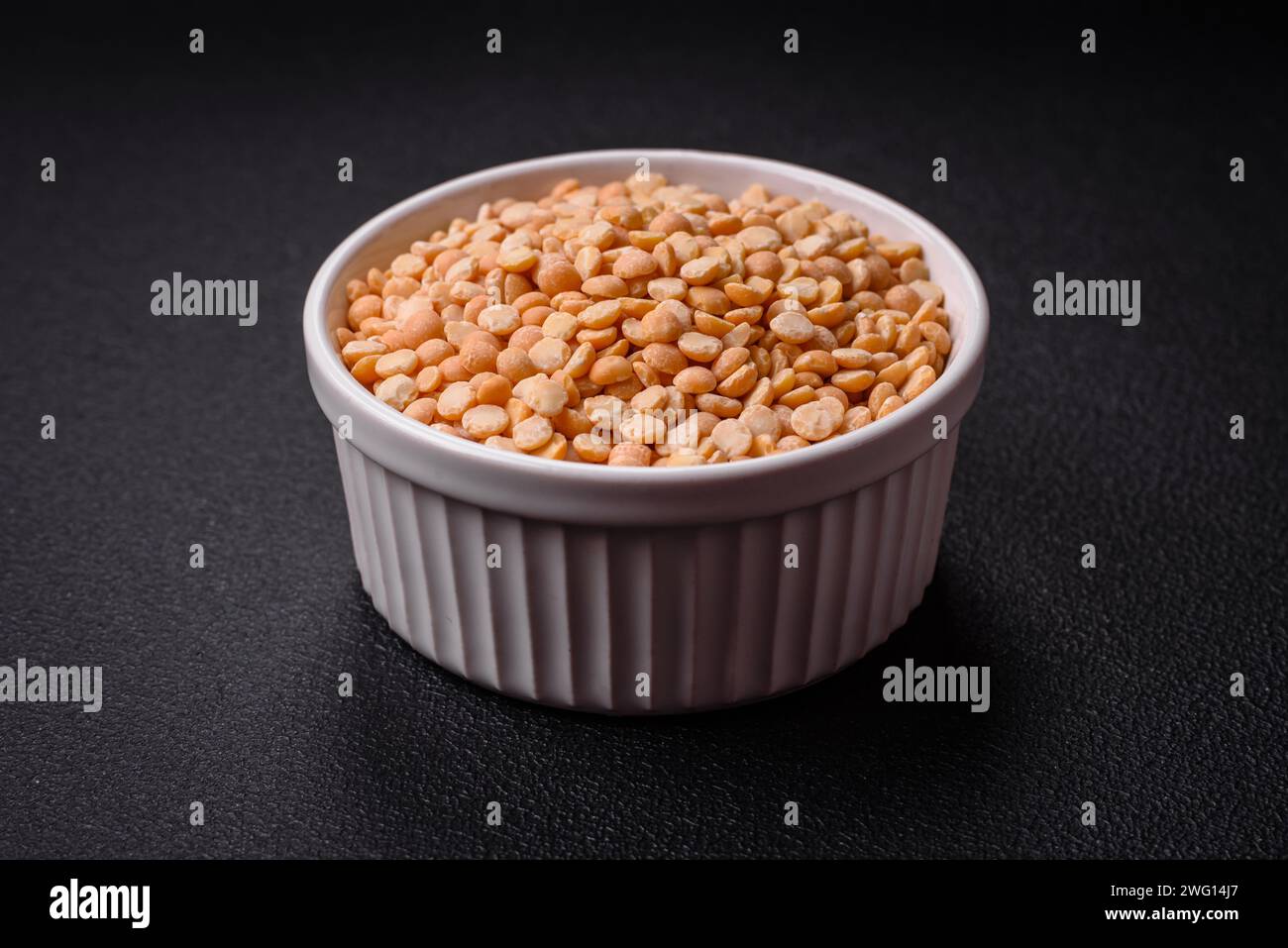 Dried pea grains, divided into halves, are yellow in color when raw ...