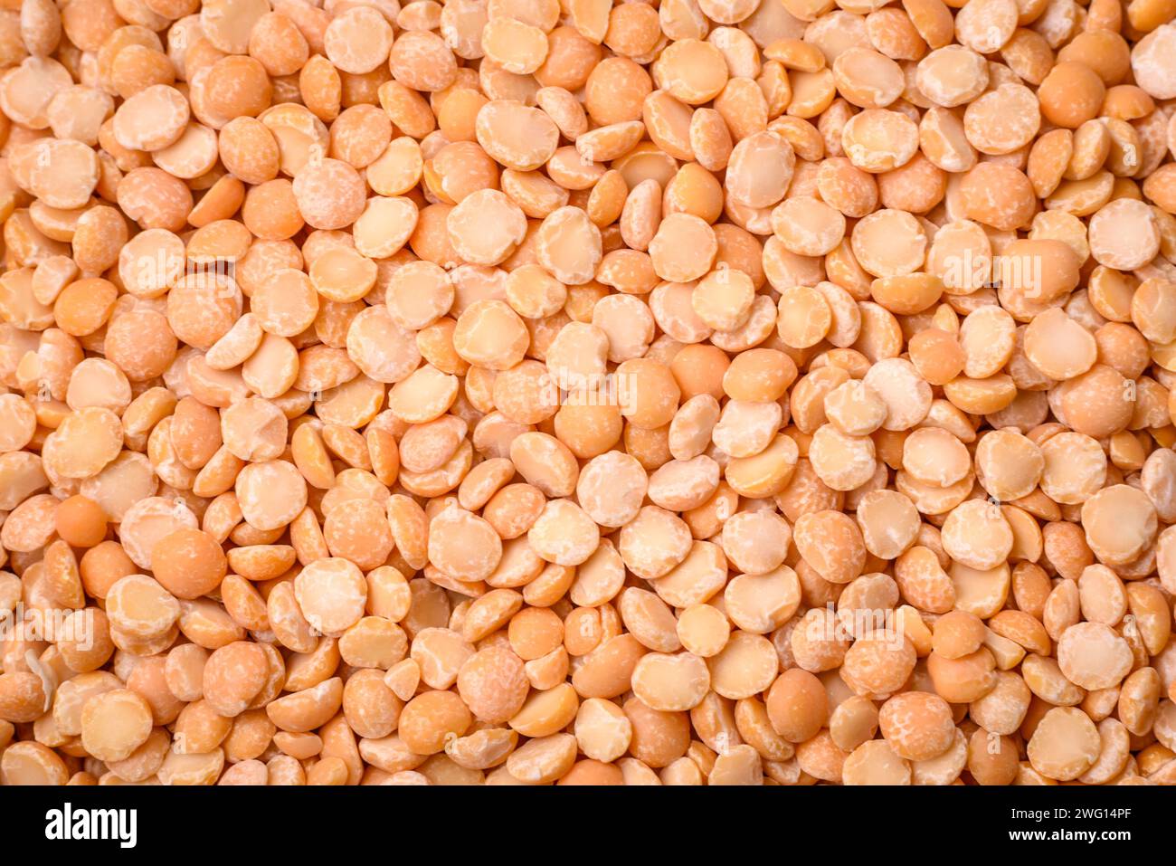 Dried pea grains, divided into halves, are yellow in color when raw ...