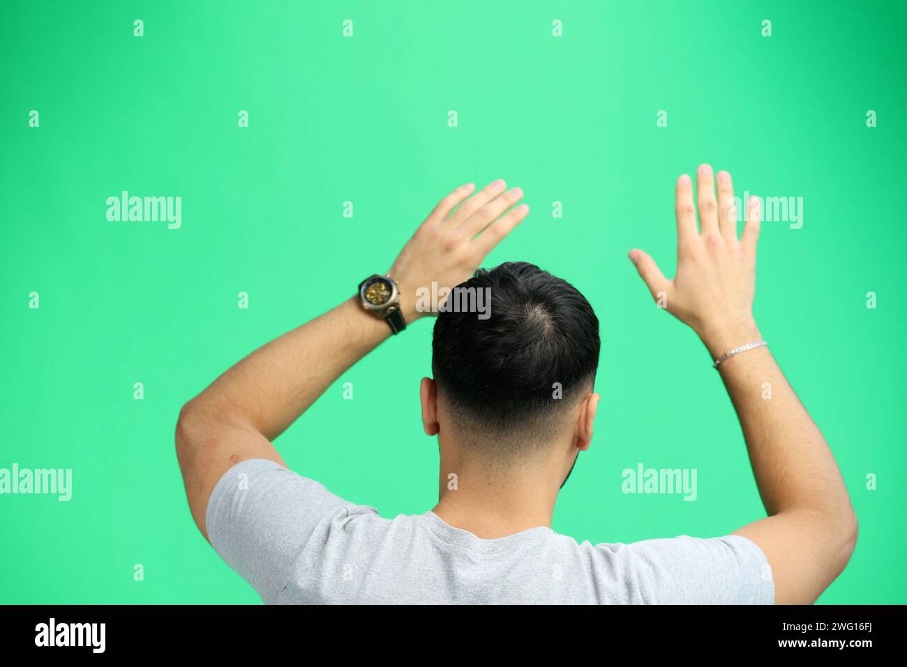 A man, close-up, on a green background, waving his arms Stock Photo - Alamy