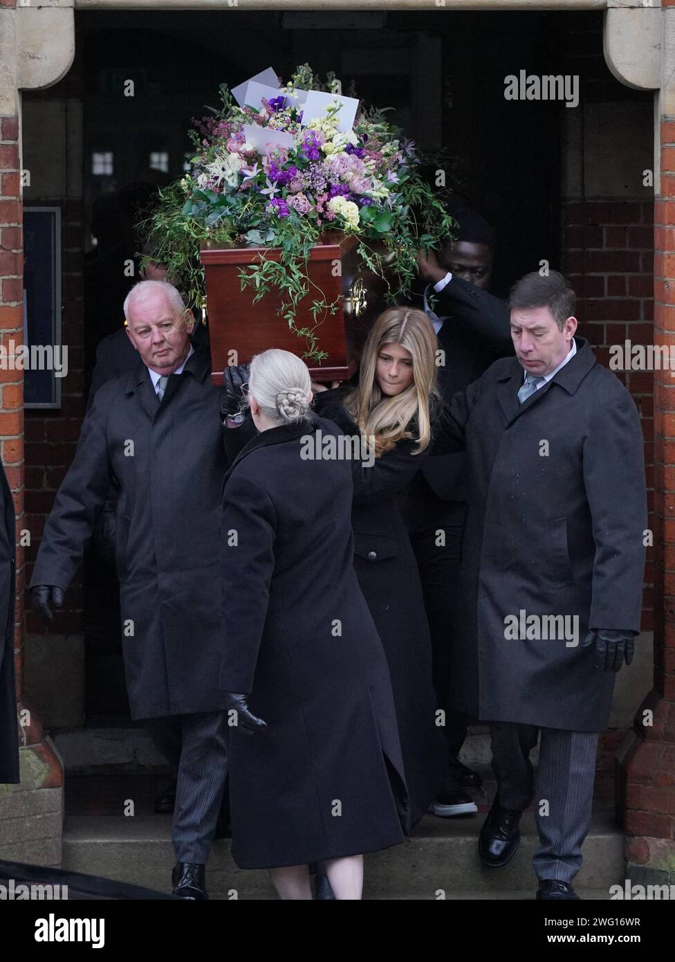 Pall bearers carry the coffin out of the funeral service of Derek ...