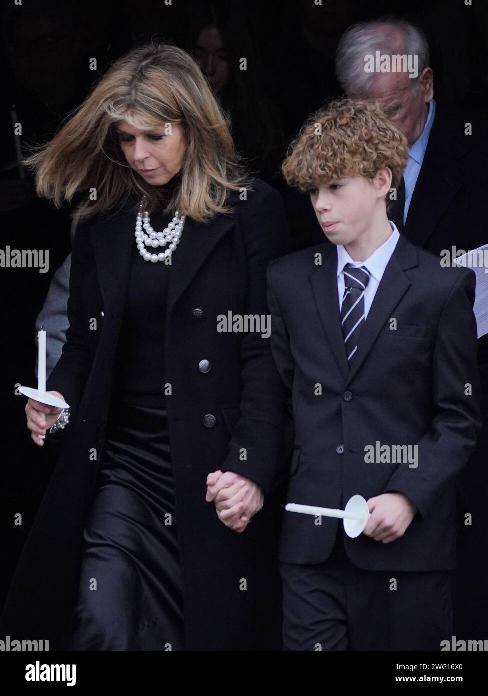 Kate Garraway follows the coffin out of the funeral service of her ...