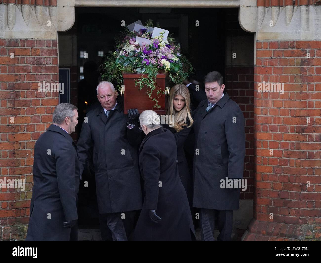 Pall bearers carry the coffin out of the funeral service of Derek ...