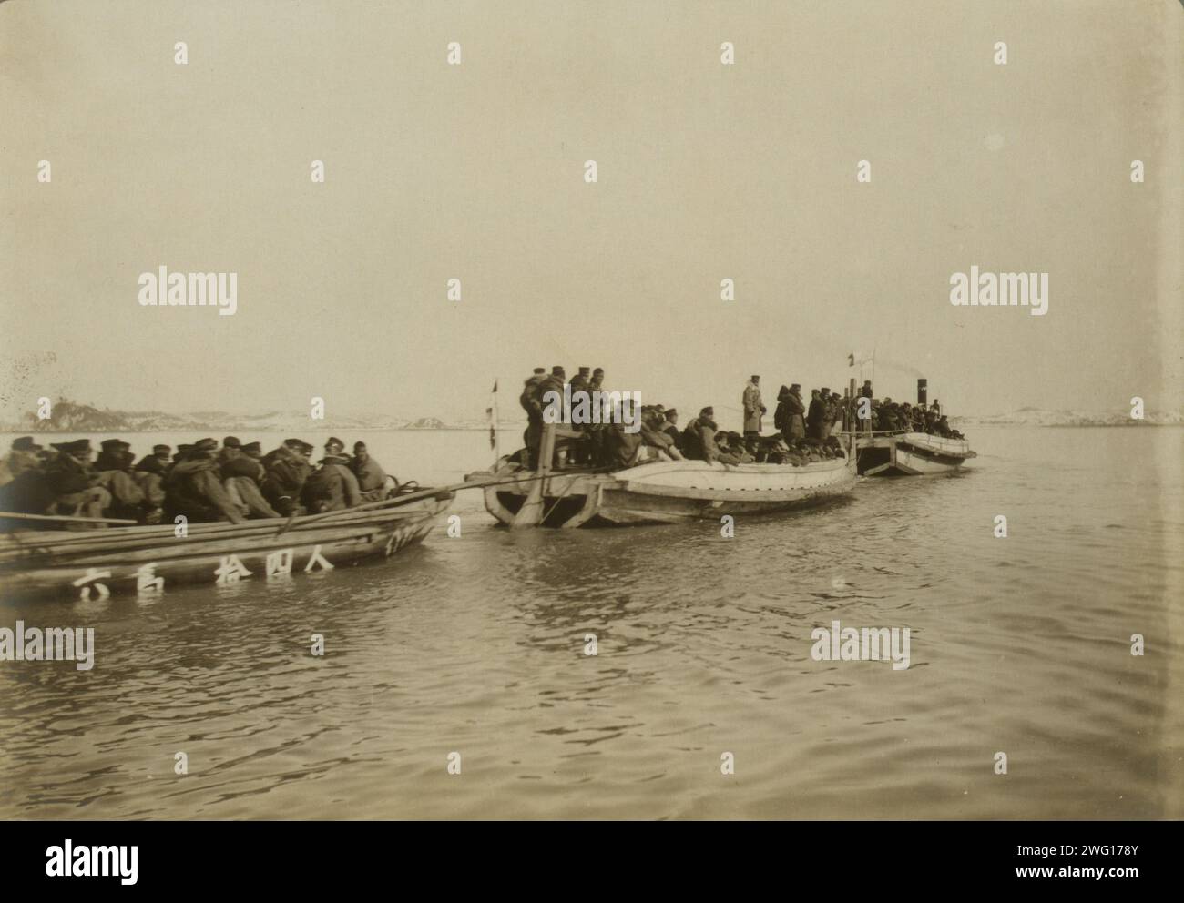 Steam launch carrying six over-crowded boat loads soldiers to landing ...