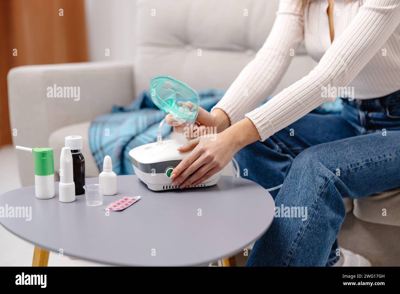 Close-up photo of sick woman with an inhaler. Unhealthy girl presses ...