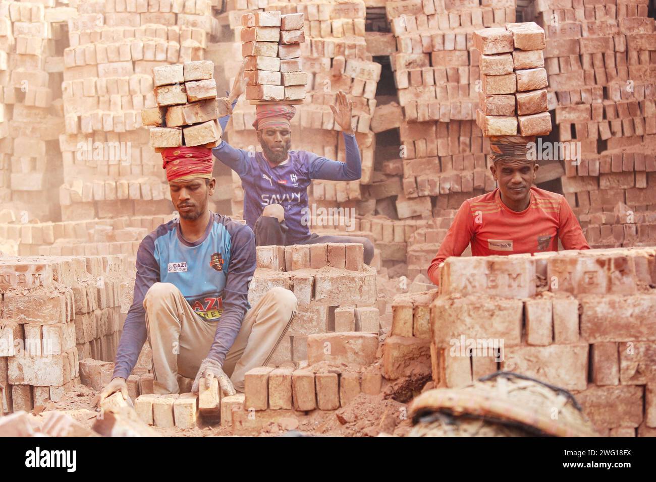 Laborers work at a brickyard on February 02, 2024, in Dhaka, Bangladesh. Bangladesh goes through ...