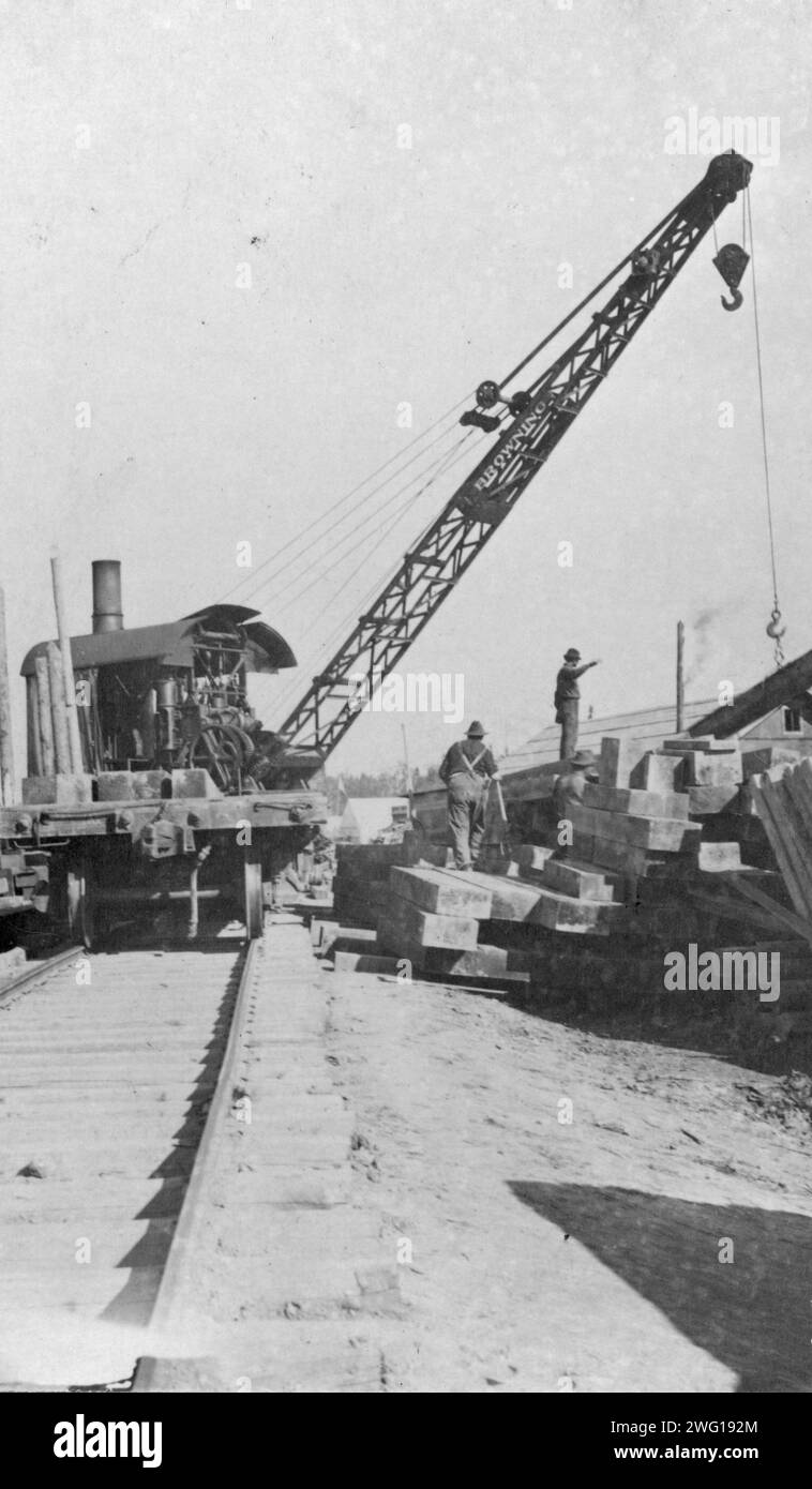 Crane being used in construction of new railway bridge, between c1900 ...