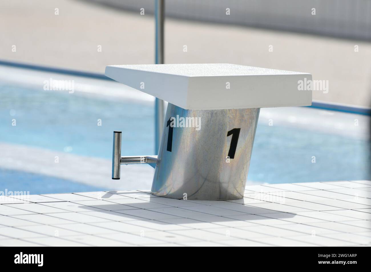 The starting blocks ready to dive into the pool Stock Photo - Alamy