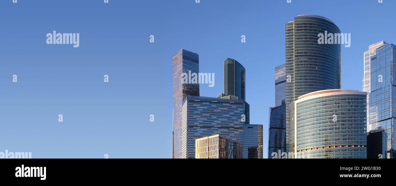 Day view of dense standing of buildings group facades in city business ...