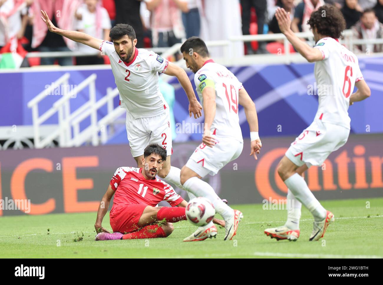 Doha, Qatar. 2nd Feb, 2024. Jordan's Yazan Alnaimat (bottom) vies for ...