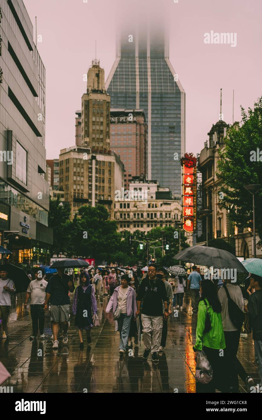 Overcrowded street Shanghai, China, rainy weather Stock Photo - Alamy