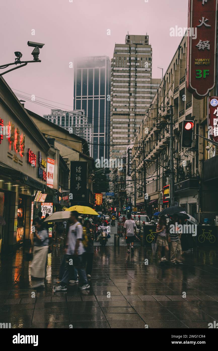 Overcrowded street Shanghai, China, rainy weather Stock Photo - Alamy
