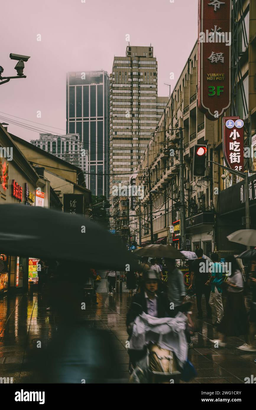 Overcrowded street Shanghai, China, rainy weather Stock Photo - Alamy