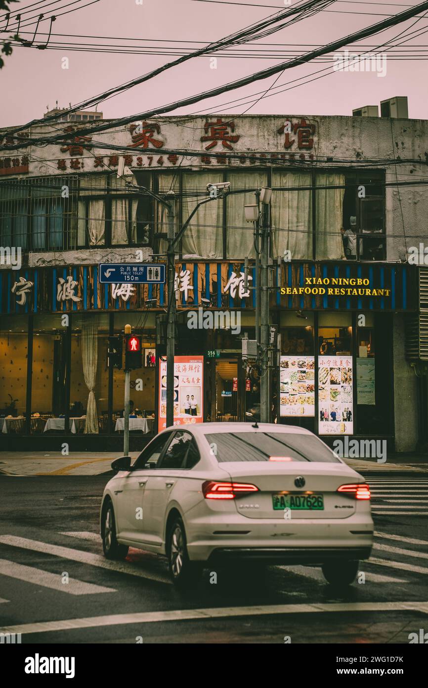 crossroad in Shanghai, China, in the background with Chinese signes ...