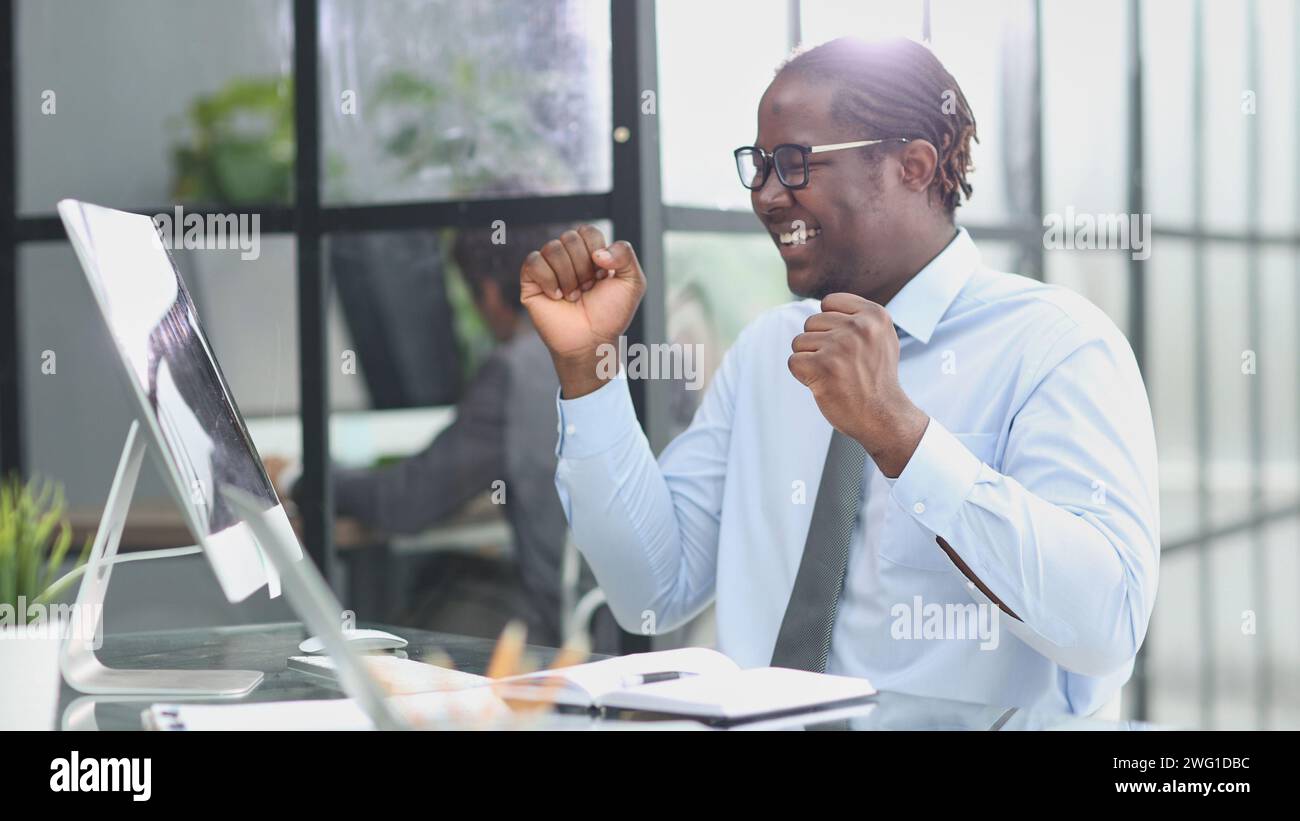 happy man working in the office. raised his hands joyfully Stock Photo ...