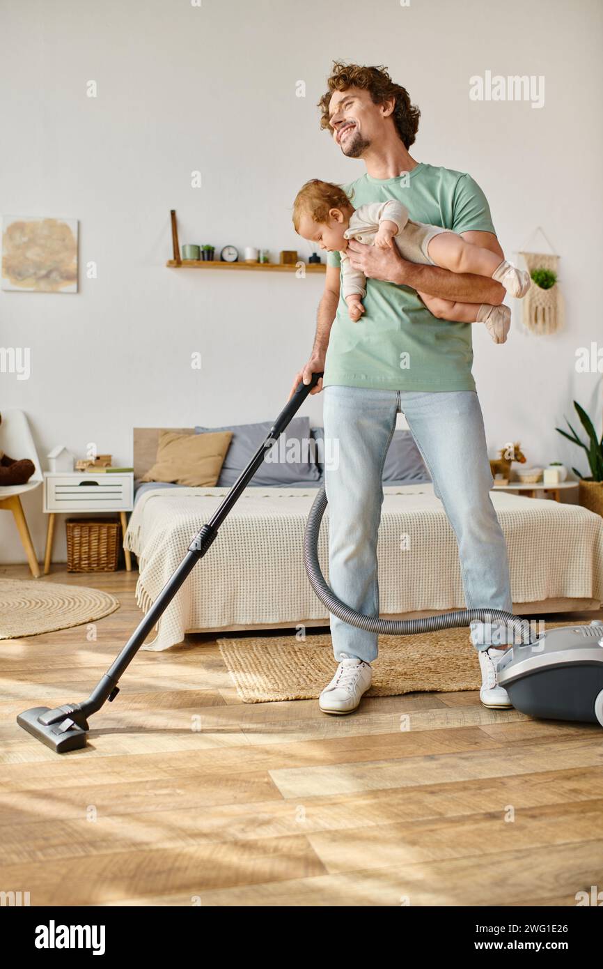 man multitasking housework and childcare, happy father vacuuming ...