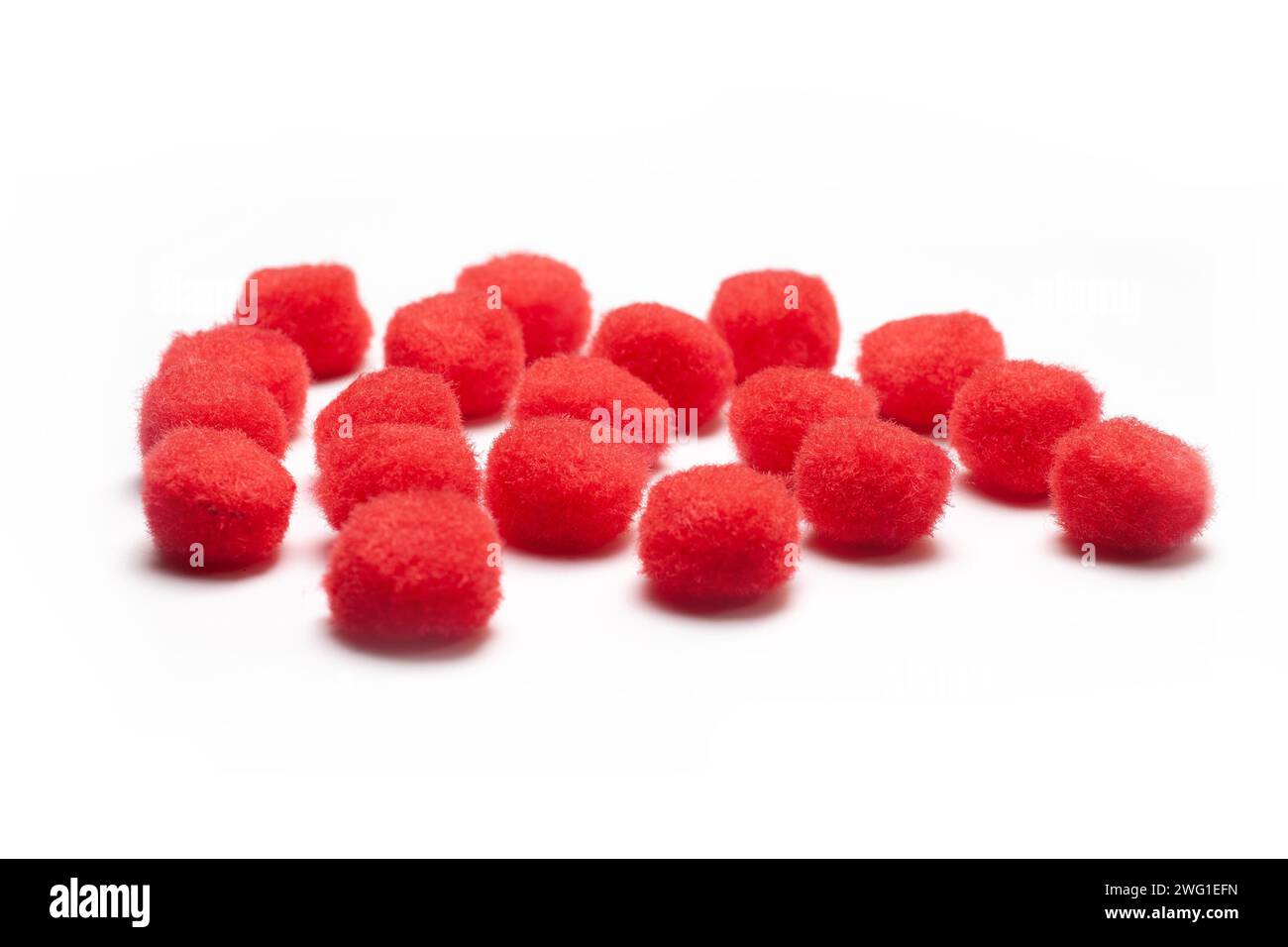 small fluffy red balls isolated on white background Stock Photo - Alamy