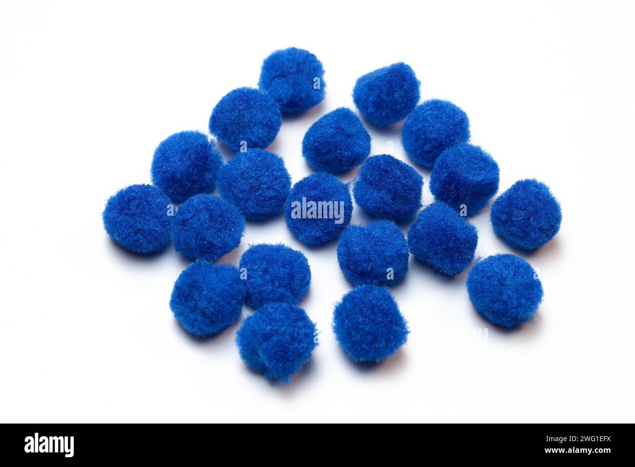 small fluffy blue balls isolated on white background Stock Photo - Alamy