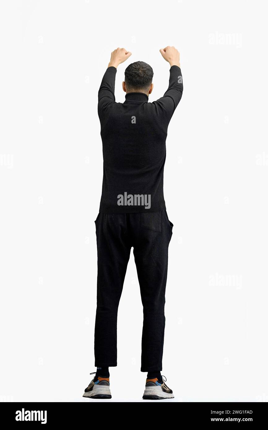 A man, full-length, on a white background, raised his hands up Stock ...