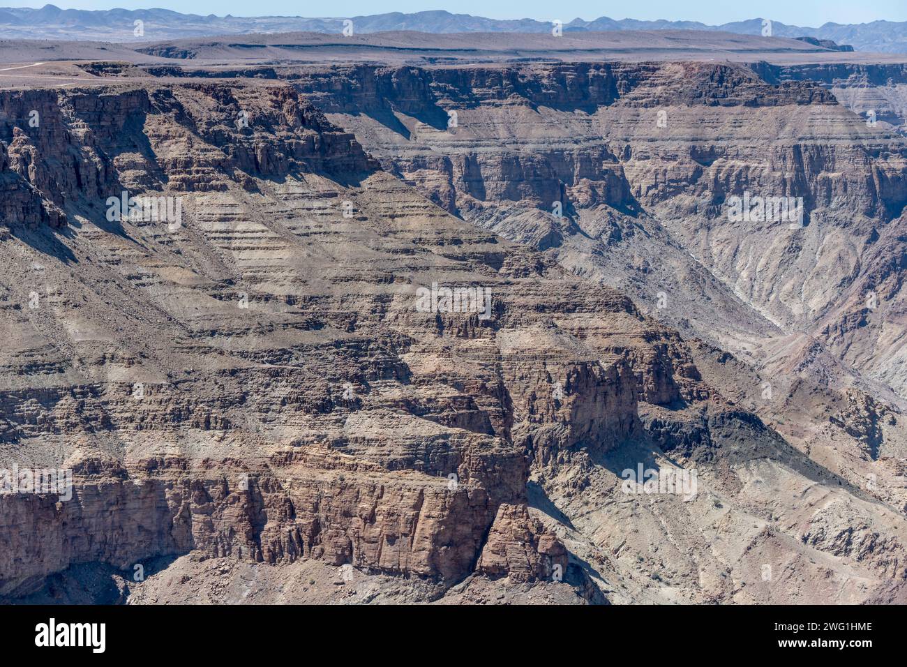 aerial landscape with escarpment layered worn slopes, shot in bright ...