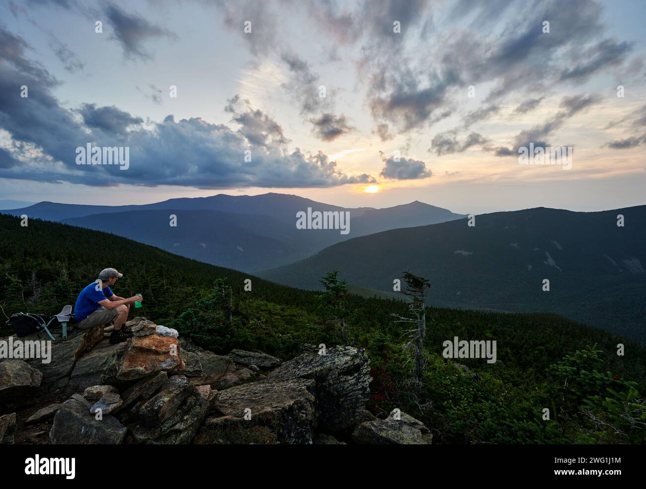 Hiker enjoying the view of Galehead Mountain at sunset, White Mountain ...