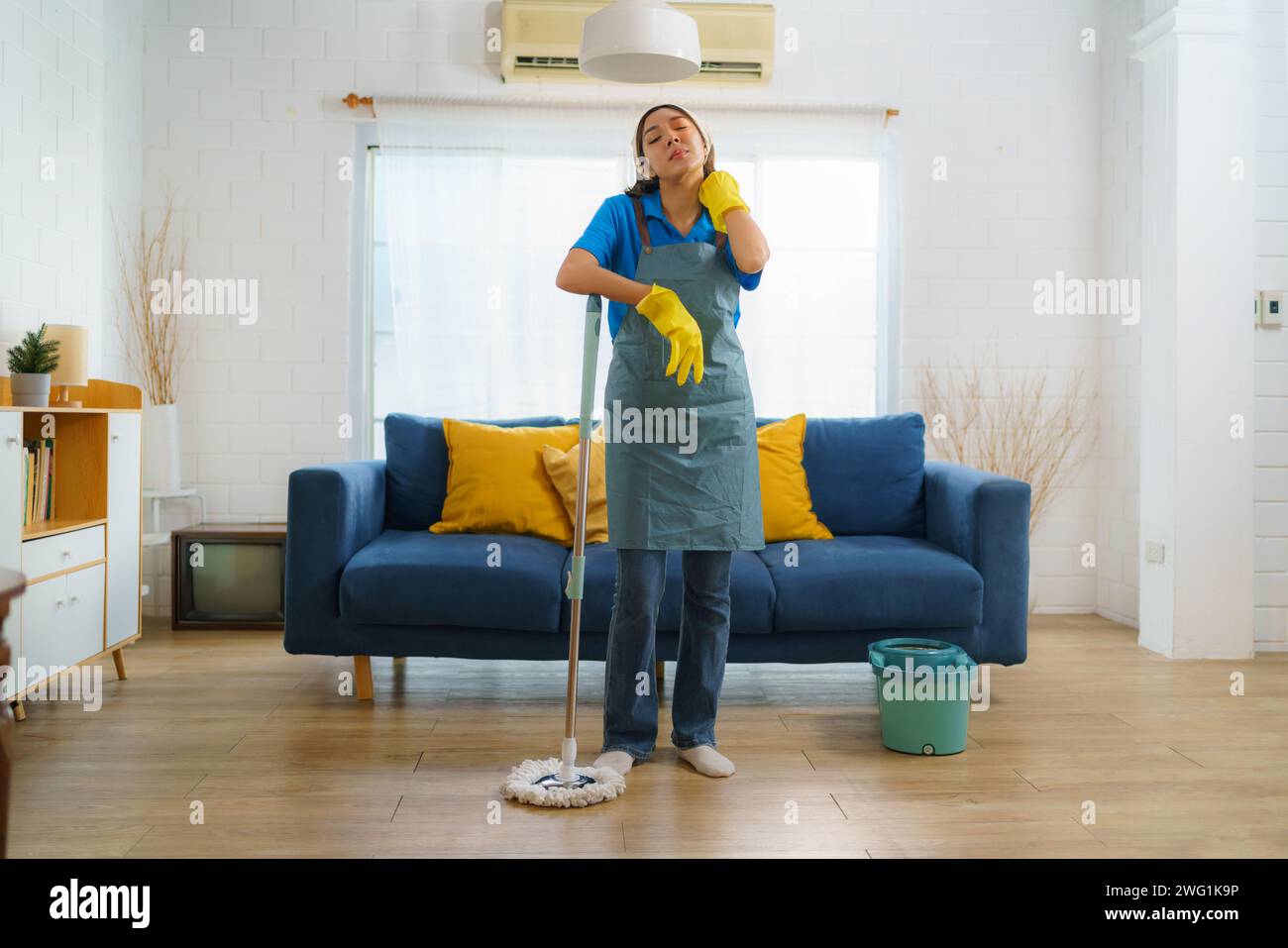 Housekeeper as she wearily clean the floor in the living room reflects ...