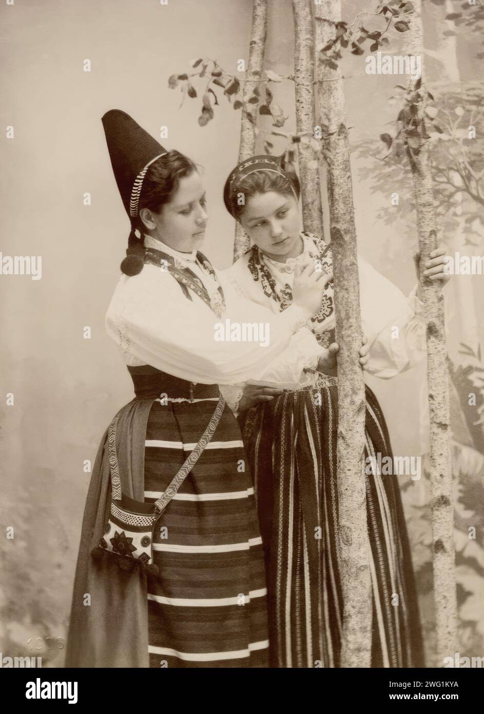 Two young women pose in different national costumes, 1890-1920 Stock Photo - Alamy