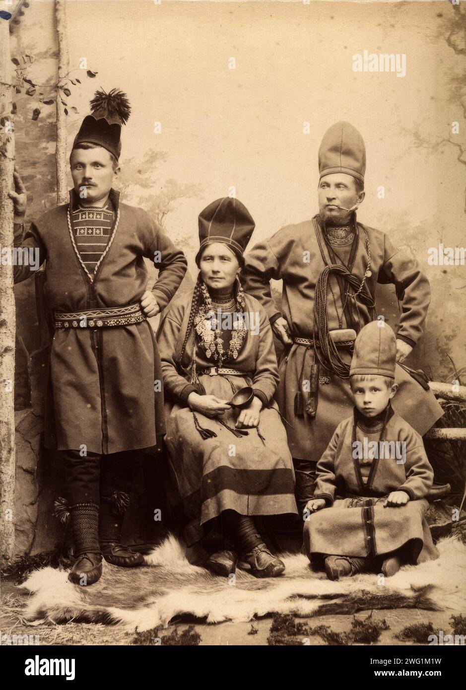 Group picture with four people wearing Sami folk costumes, 1912. Studio ...