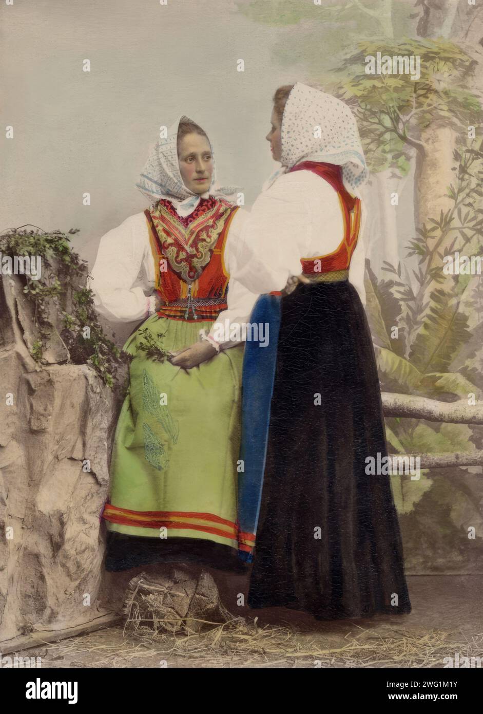 Two young women pose in folk costumes, with dotted headdresses, 1886 ...