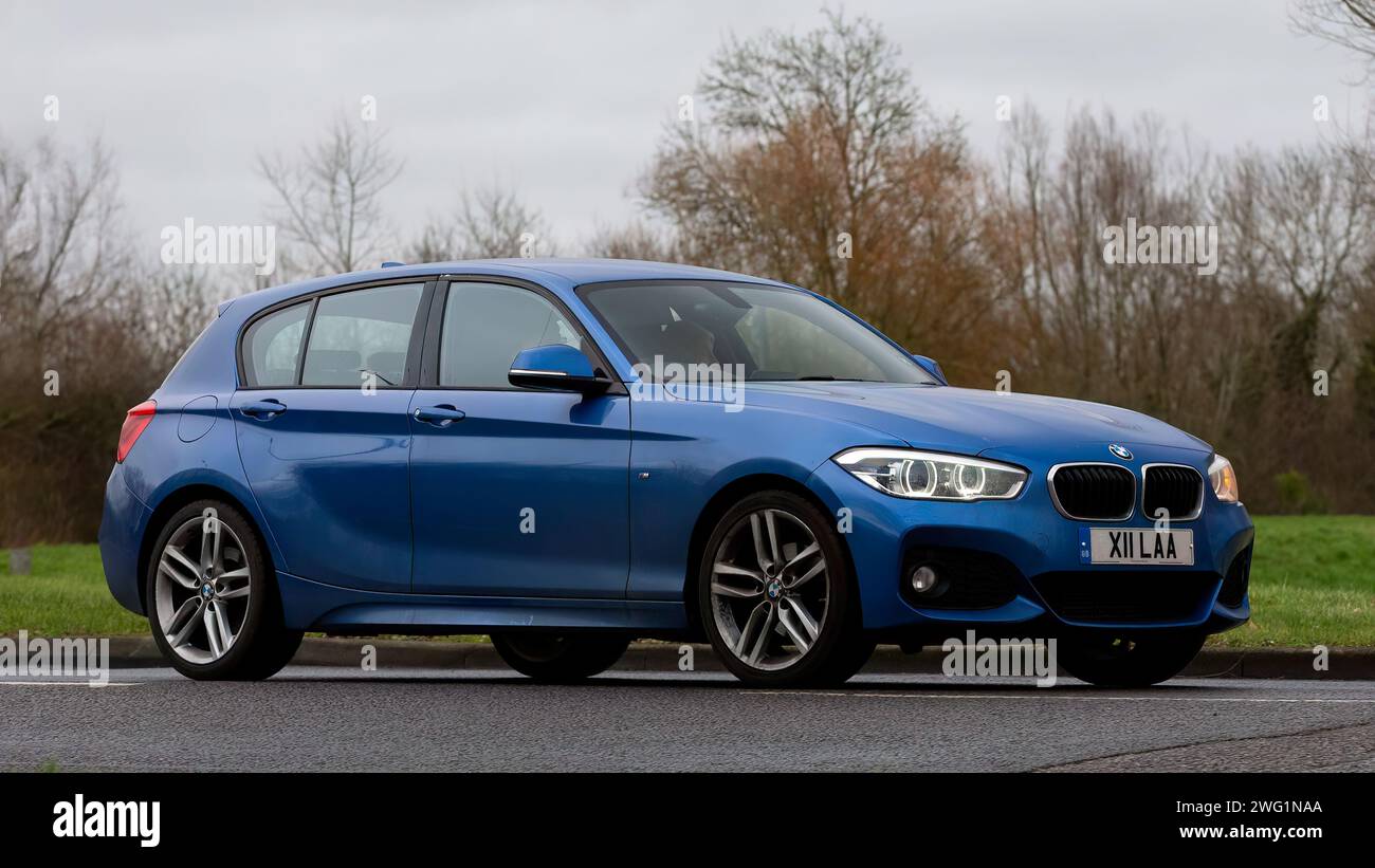 Milton Keynes,UK-Jan 18th 2024:2015 blue BMW 120D XDrive M Sport car driving on an English ...
