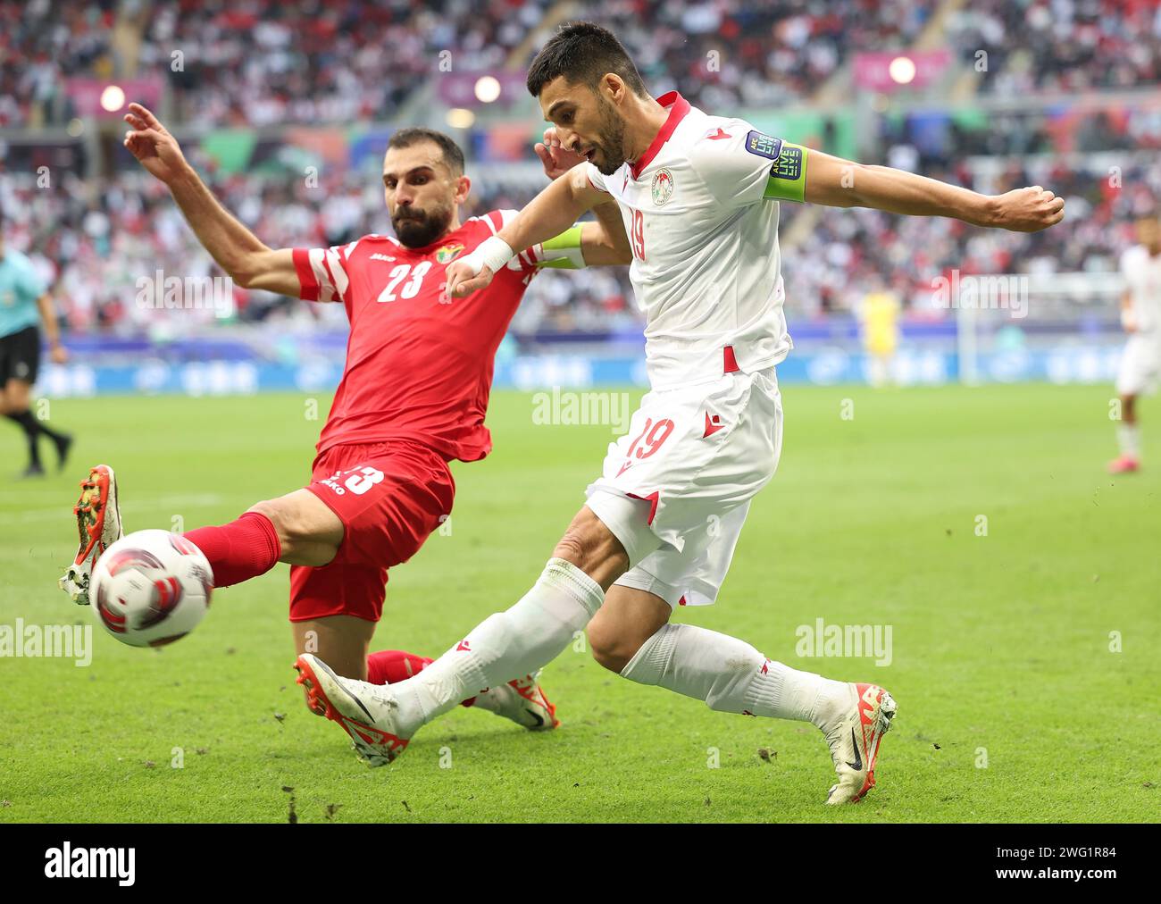 Doha, Qatar. 2nd Feb, 2024. Tajikistan's Akhtam Nazarov (R) shoots past ...