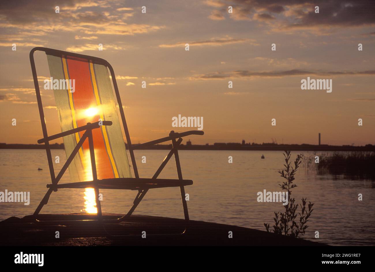 Folding chair in the sun Stock Photo - Alamy