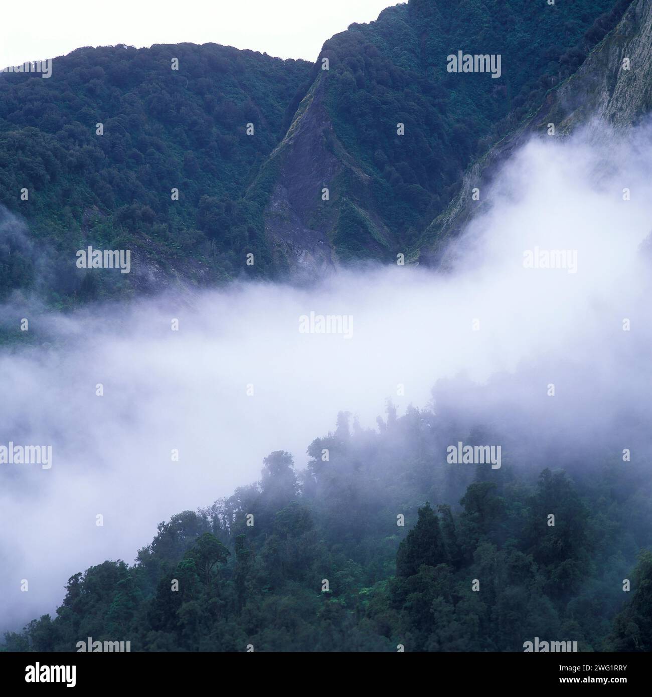 Cloudes on mountain slope Stock Photo - Alamy