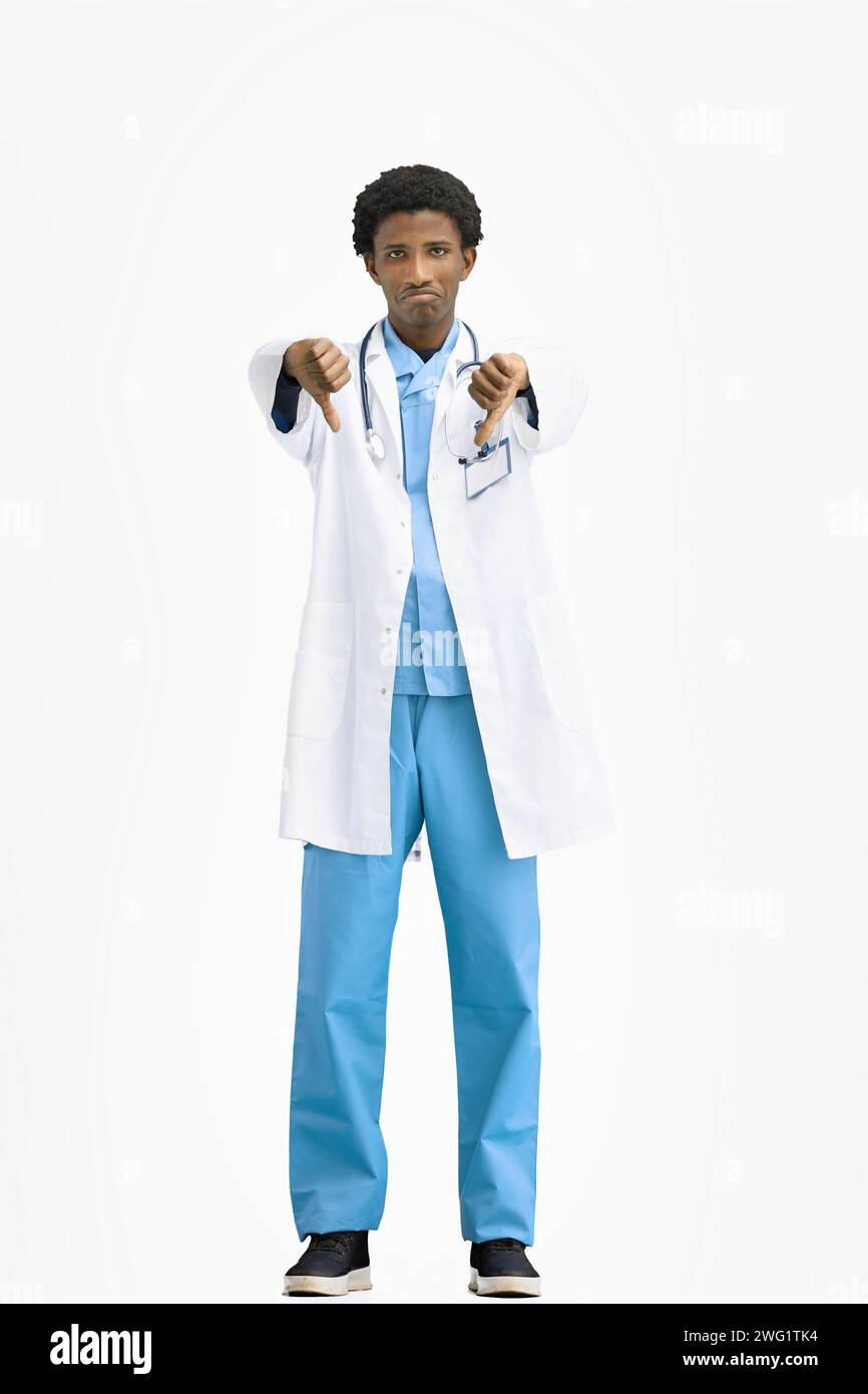 The doctor, in full height, on a white background, shows his thumbs ...