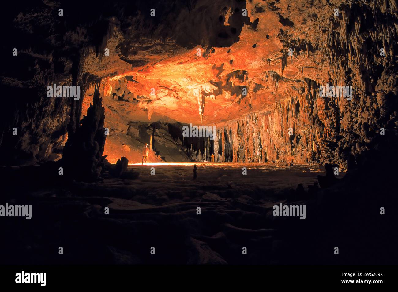 Large cavern with several cavers, lit by powerful strobe. Actun ...